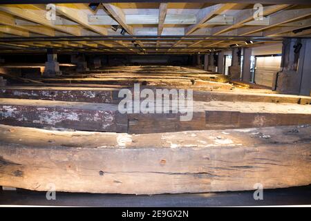 The wooden hull of a tall ship under construction at the Port of ...