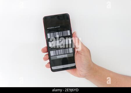 Detail photo of imei code on the mobile phone screen in hand isolated ...