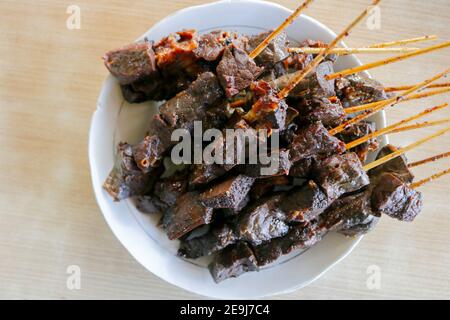 Sate Paru or beef's lung satay with soft texture. Traditional food from ...