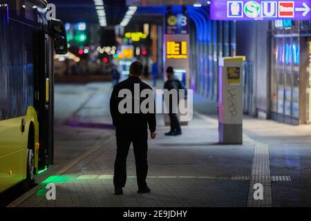 Essen, Germany. 05th Feb, 2021. People wait for their bus at the main ...