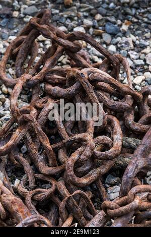 a rusty chain on the ground Stock Photo - Alamy