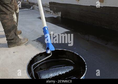 Bitumen primer for flat roof waterproofing Stock Photo - Alamy