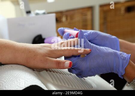Senior woman receives a manicure Stock Photo - Alamy