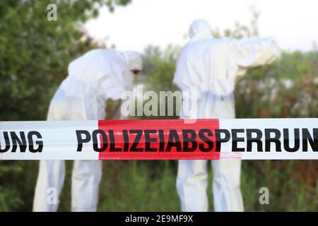 Symbolic image: Police cordon with forensics in the background Stock ...