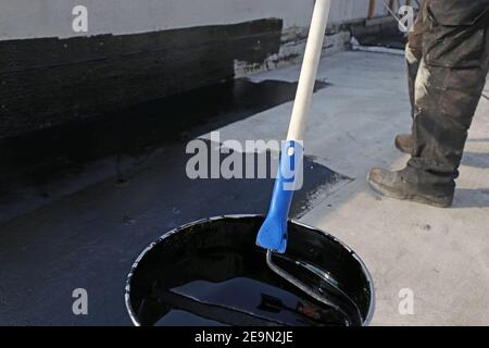 Bitumen primer for flat roof waterproofing Stock Photo - Alamy