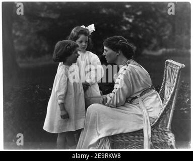 Mrs. Frank Vanderlip seated on porch, with two children, not after 1913 ...