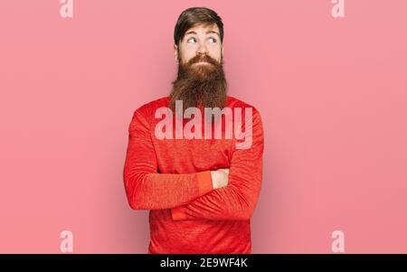 Redhead man with long beard wearing basketball uniform showing muscles ...