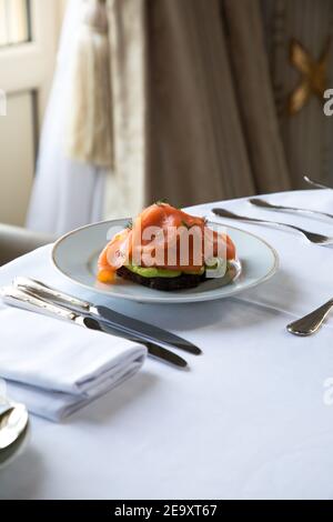 Served table for breakfast with toast, coffee and butter on tablemat ...
