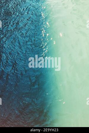 Aerial top view of waving shiny seawater in two different colors Stock ...