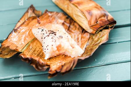 Thai traditional dessert. Grilled Taro Stuffed Coconut Sticky Rice ...