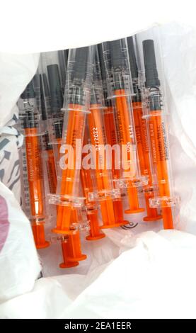 Photo of Transparent black and orange used plastic syringes pre filled ...