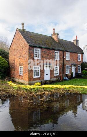 Frogmore Cottages showing sandbags to protect the building from the ...