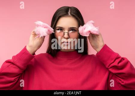 Happy woman showing cotton candy with flowers Stock Photo - Alamy
