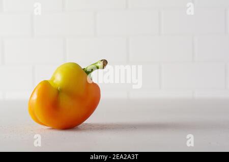 Ugly pepper that looks like a strange face on a light table. Funny ...