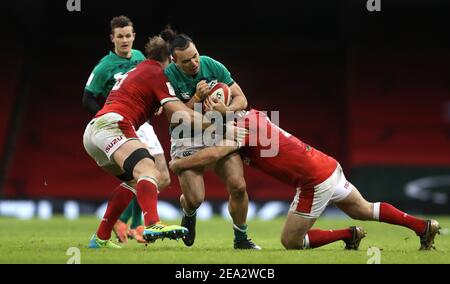 Ireland's James Lowe is tackled by Wales' Ellis Mee and Tomos Williams during the Guinness Men's ...