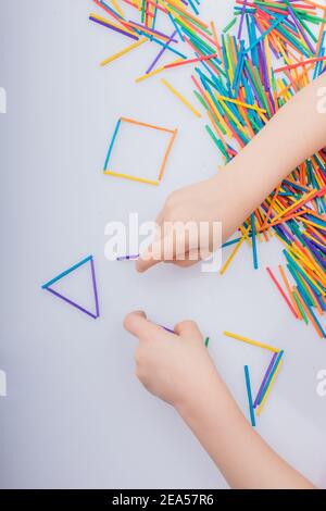 Kid making rectangular and triangle shape as creative concept Stock ...
