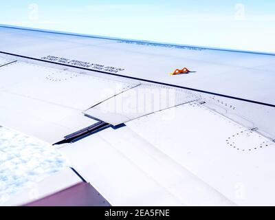 Overwing plane window view Stock Photo - Alamy