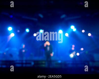 Blurred rock concert performing on stage with musician with purple ...