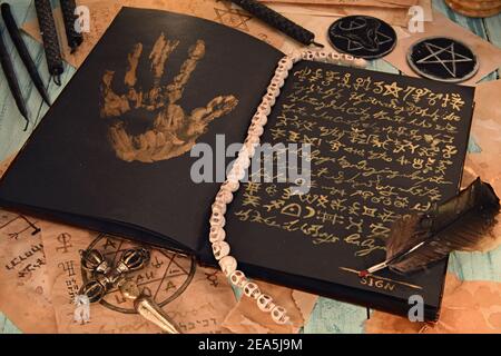 Open grimoire book of magic spells and ritual objects. Esoteric, gothic ...
