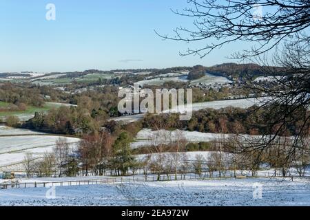 Snow-dusted pastureland, Bybrook Valley and Colerne village, Wiltshire ...