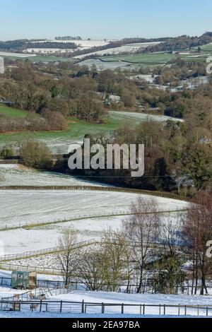 Snow-dusted pastureland, Bybrook Valley and Colerne village, Wiltshire ...