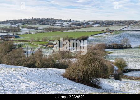 Snow-dusted pastureland, Bybrook Valley and Colerne village, Wiltshire ...