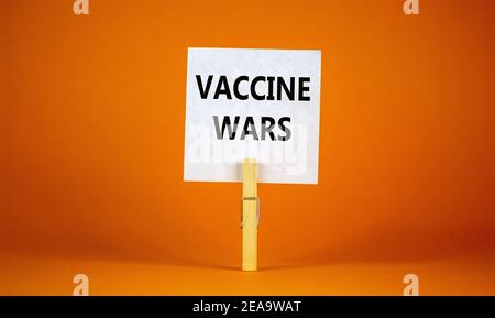 COVID-19 vaccine wars symbol. White paper with text 'vaccine wars ...