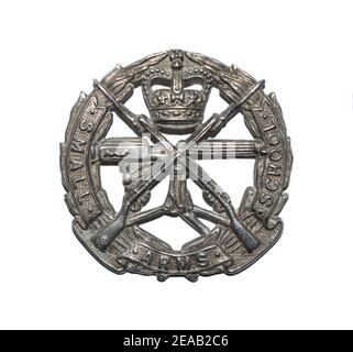 A cap badge of the Small Arms School Corps c. 1929-1952 Stock Photo - Alamy