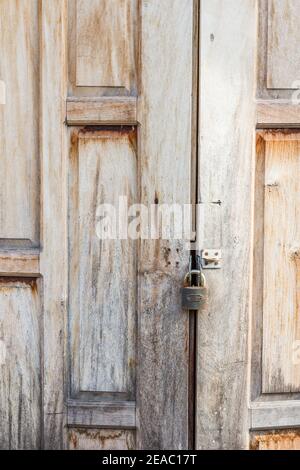 Open door made of wooden planks with warning signs on it, site entrance ...