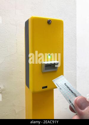 Yellow ticket validation machine on a modern public transport bus ...