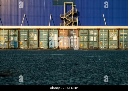 View of many shipping containers doors with fire escape background ...