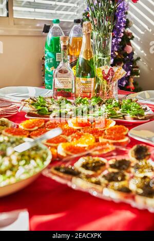 Family party. A table laid with salads and fresh fruits and vegetables ...