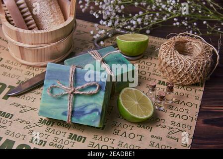 Fragrant handmade soap, lemon and lime, lie on the packaging paper with ...