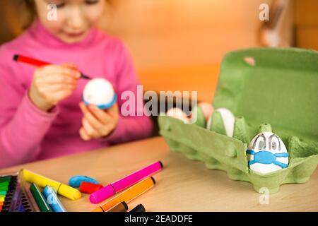 Girl with bunny ears makes medical masks out of plasticine for Easter ...
