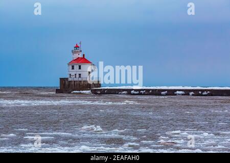 Superior Entry Lighthouse with ice along the Lake Superior shore in ...