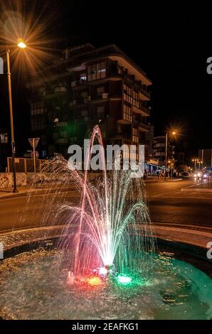 Illuminated Italian tricolor fountain in an urban center Stock Photo ...