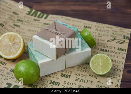 Fragrant handmade soap, lemon and lime, lie on the packaging paper with ...
