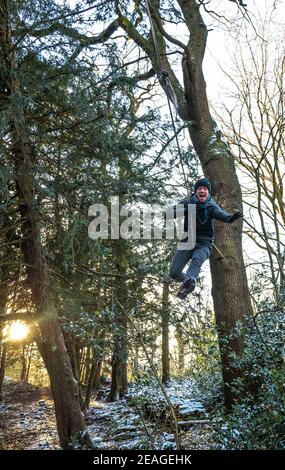 Man Swinging on Rope Stock Photo - Alamy