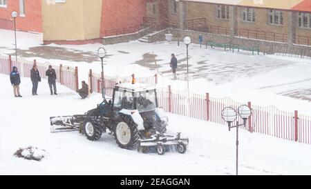 Man cleaning snow from snowplow truck Stock Photo - Alamy