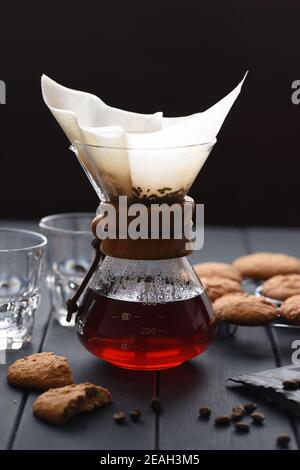 Brewing coffee with a filter dripper. Coffee dripping through a paper ...