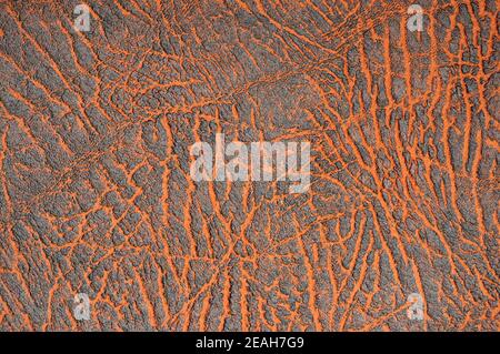 Fragment of natural brown leather with wrinkles and folds close-up ...