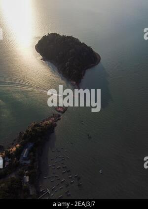 Aerial view fishing boat back to village Stock Photo - Alamy