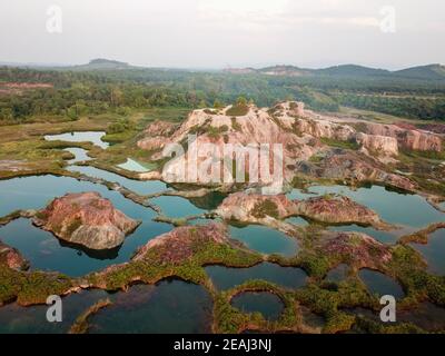 A scenic view of a lake surrounded by green hills under a cloudless ...