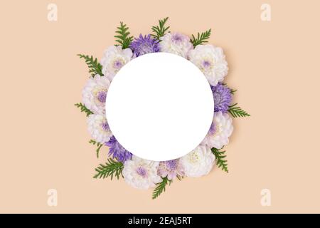 Wreath made of dahlia on a beige background. Flower round frame with ...