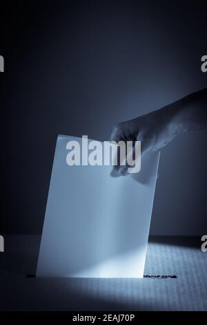 Conceptual image of a person voting, casting a ballot at a polling ...