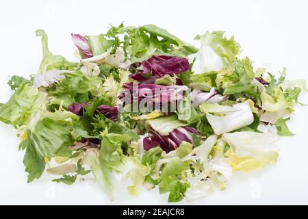 Vibrant green arugula and red radicchio salad mix in rustic woven ...