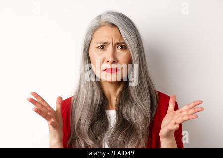 Portrait of confused businesswoman, staring puzzled and frustrated ...