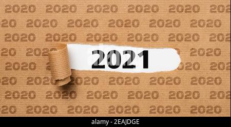 Torn paper revealing the number 2021 Stock Photo - Alamy