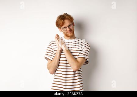 Cunning redhead man having plan, rubbing palms and looking devious at ...