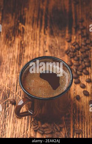 Brewed black coffee in metal mug over wooden surface Stock Photo - Alamy